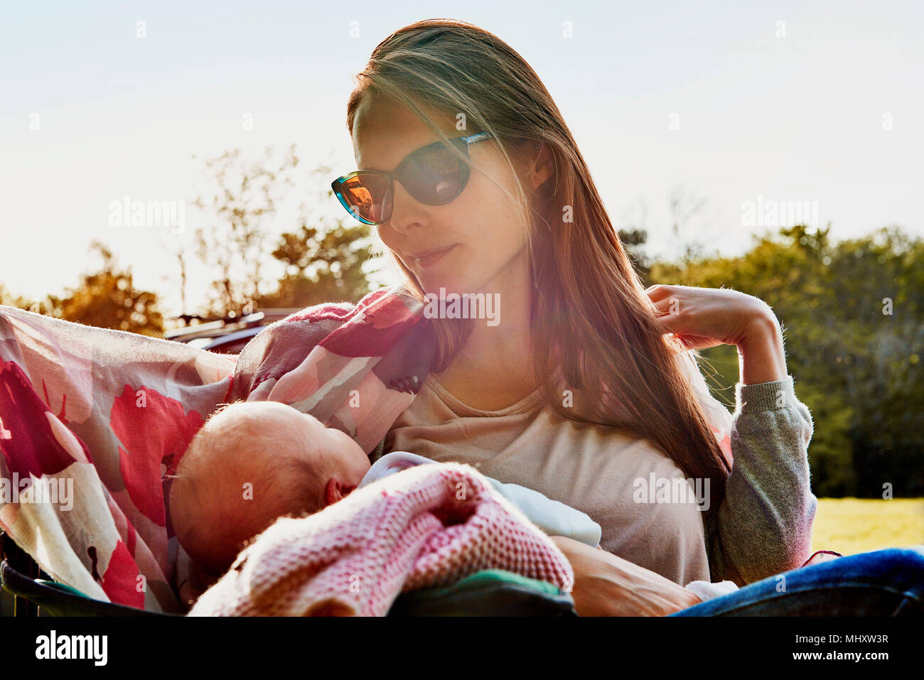 Woman cradling baby hi-res stock photography and images - Alamy