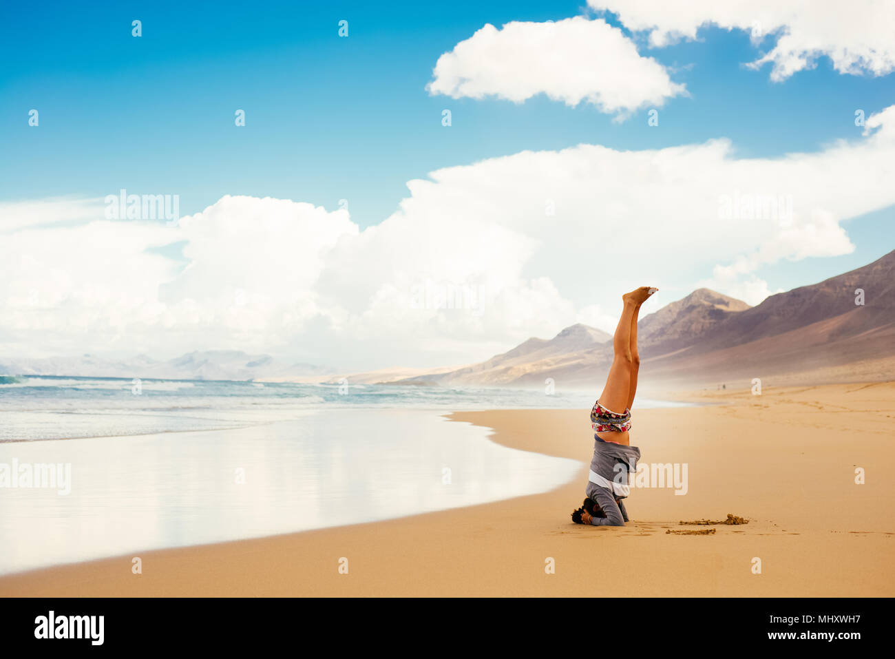 Woman doing headstand on beach hi-res stock photography and images - Alamy