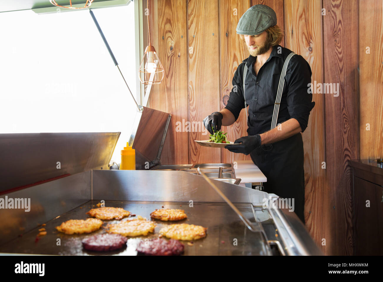 Cook working in food truck, Innsbruck Tirol, Austria Stock Photo - Alamy