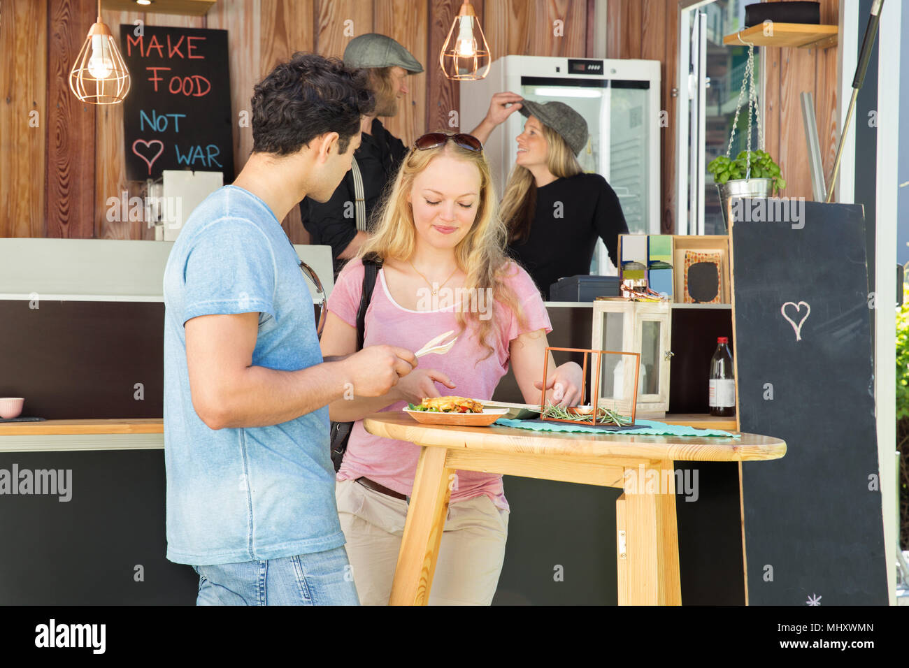 Customers enjoying meal at food truck Stock Photo - Alamy