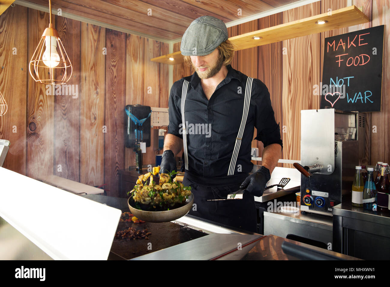 Cook working in food truck Stock Photo - Alamy
