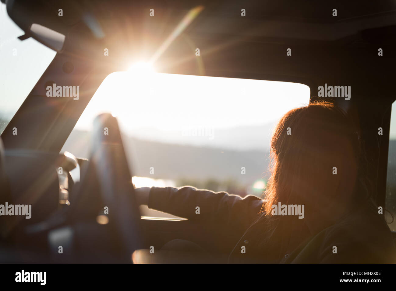 Woman looking out of car window Stock Photo - Alamy