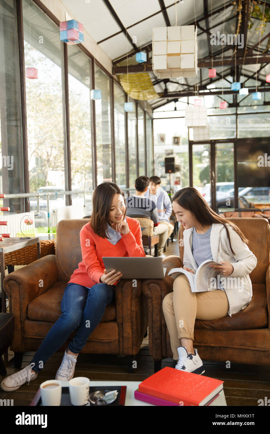 Young women study in coffee shop Stock Photo - Alamy