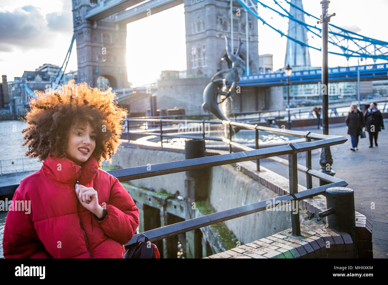 Portrait of young girl, outdoors, Tower Bridge in background, London ...