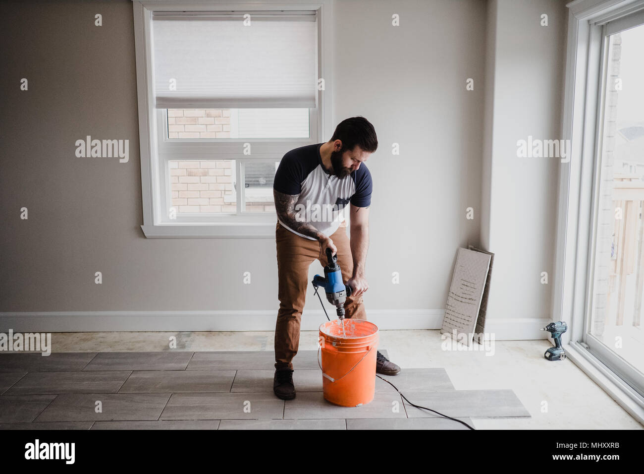 Mixing cement in bucket hi-res stock photography and images - Alamy