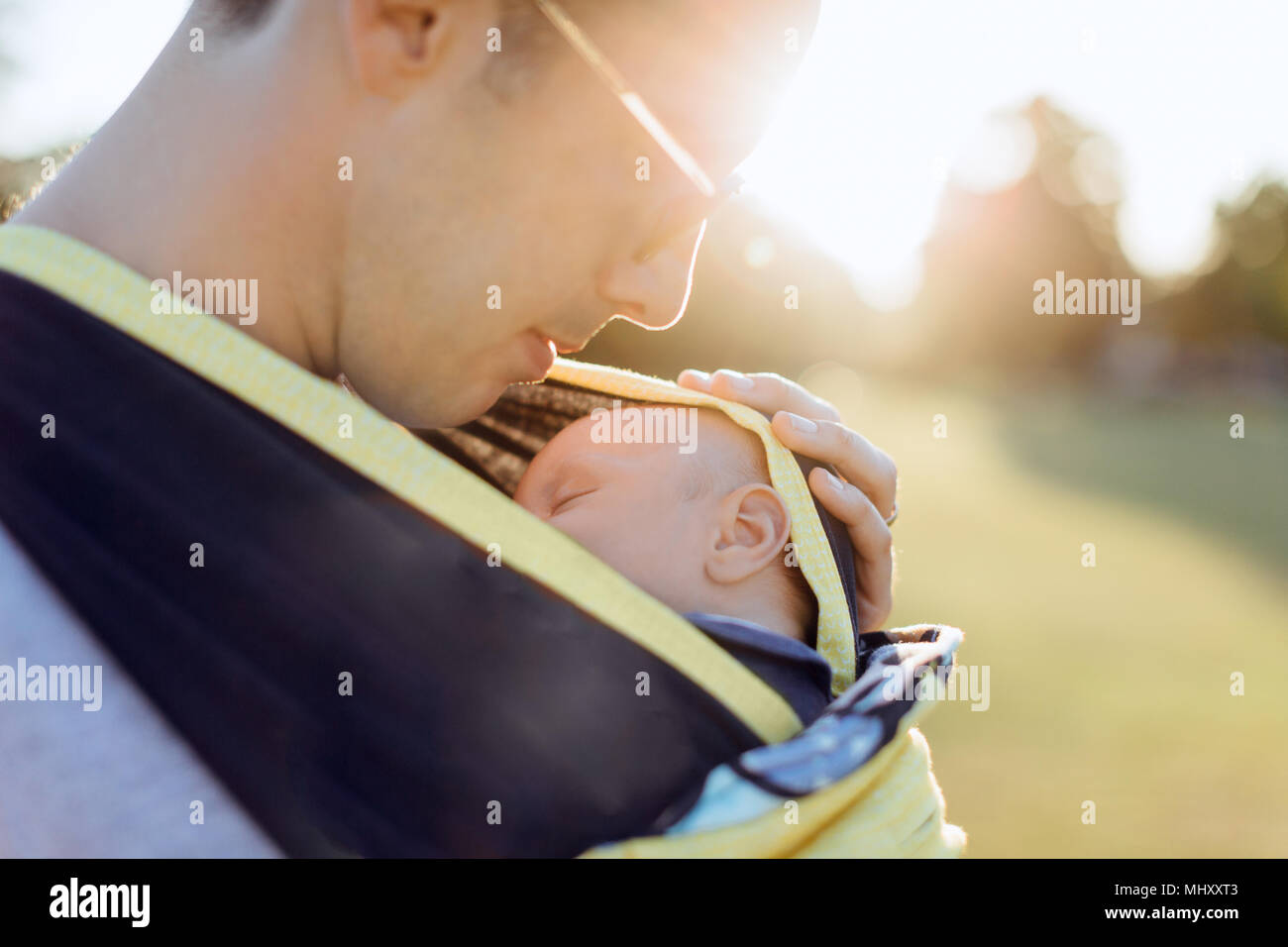 Father carrying baby boy in baby carrier Stock Photo - Alamy