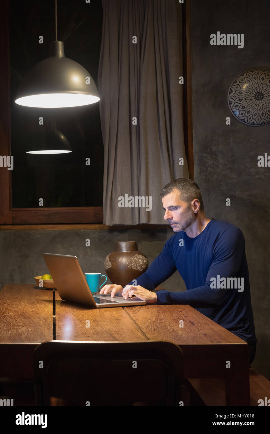 Mature male typing on laptop hi-res stock photography and images - Alamy