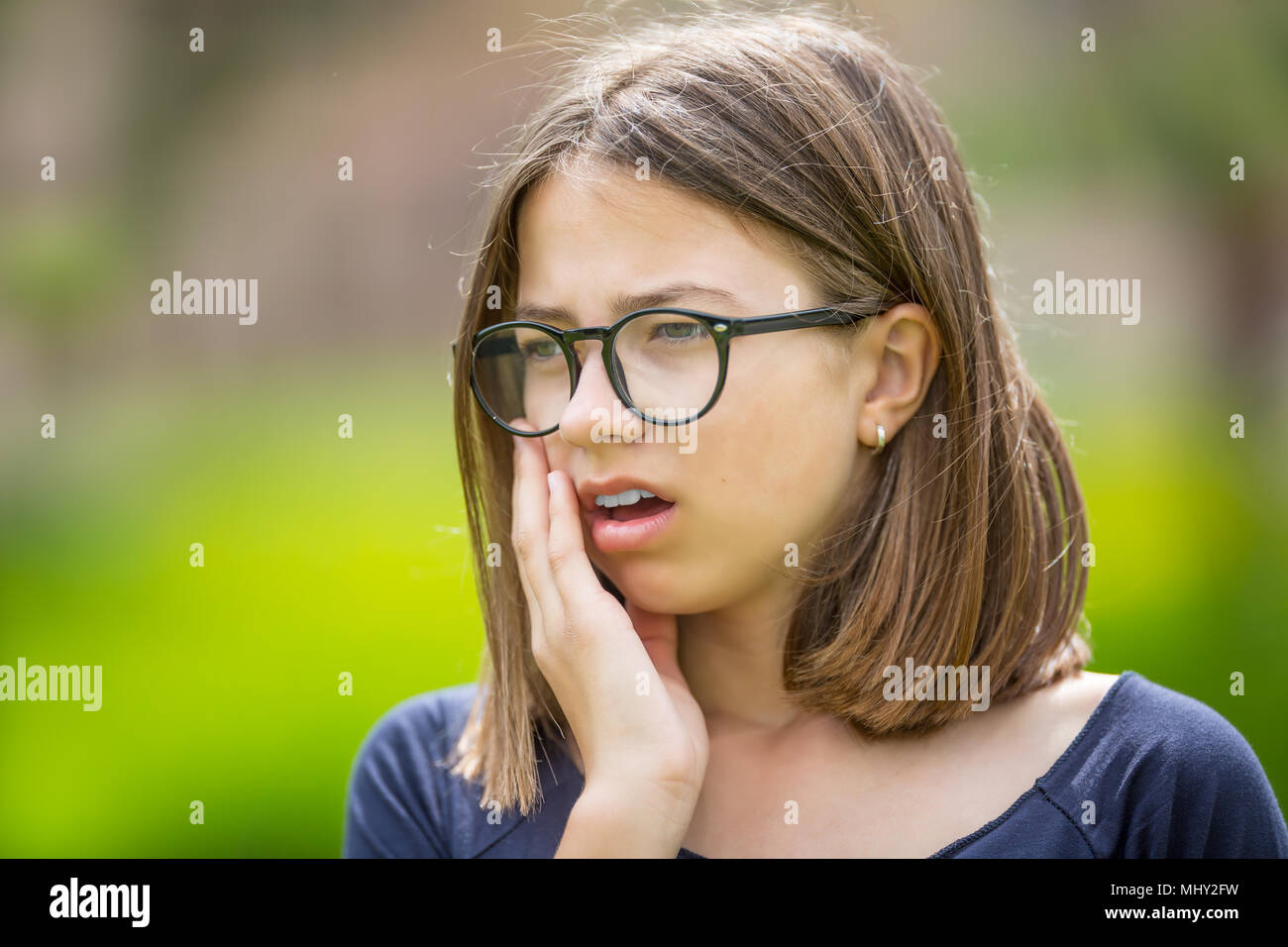 Pretty caucasian young teenage girl have a toothache Stock Photo - Alamy