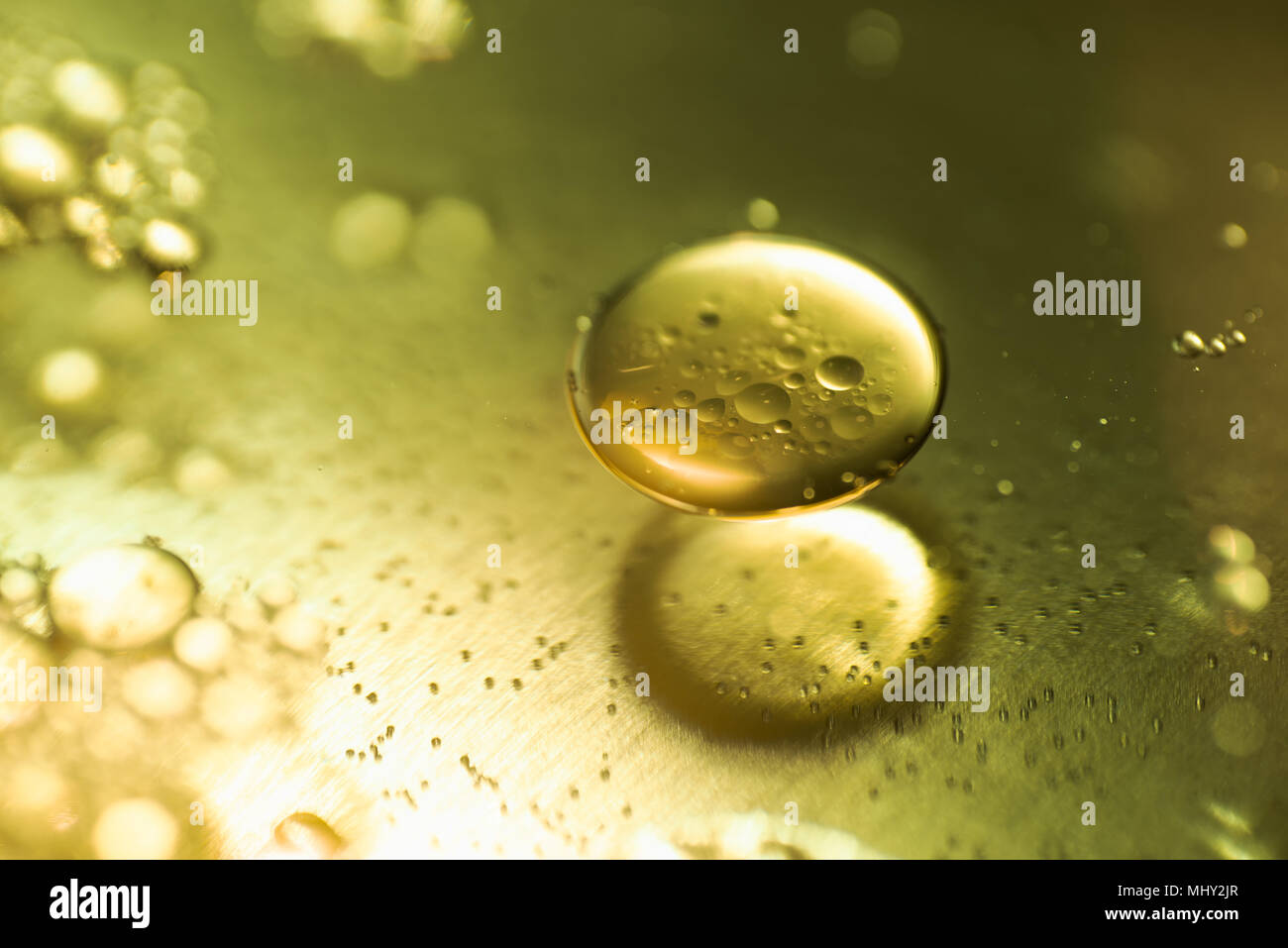 Oil drops and bubbles on a metal gear engine surface. Closeup photo ...