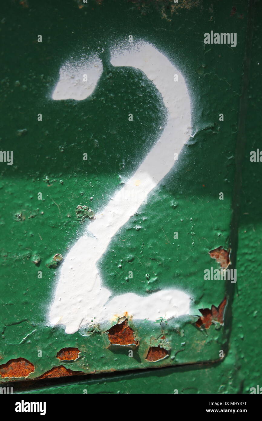 The number two spray painted in white paint onto a green metal ...