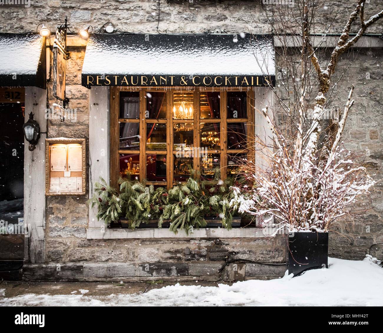 Window of a restaurant, covered in snow, in downtown Montreal, Canada ...