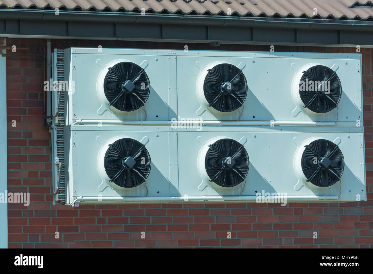 Compressor of an air conditioning mounted on a house wall Stock Photo ...