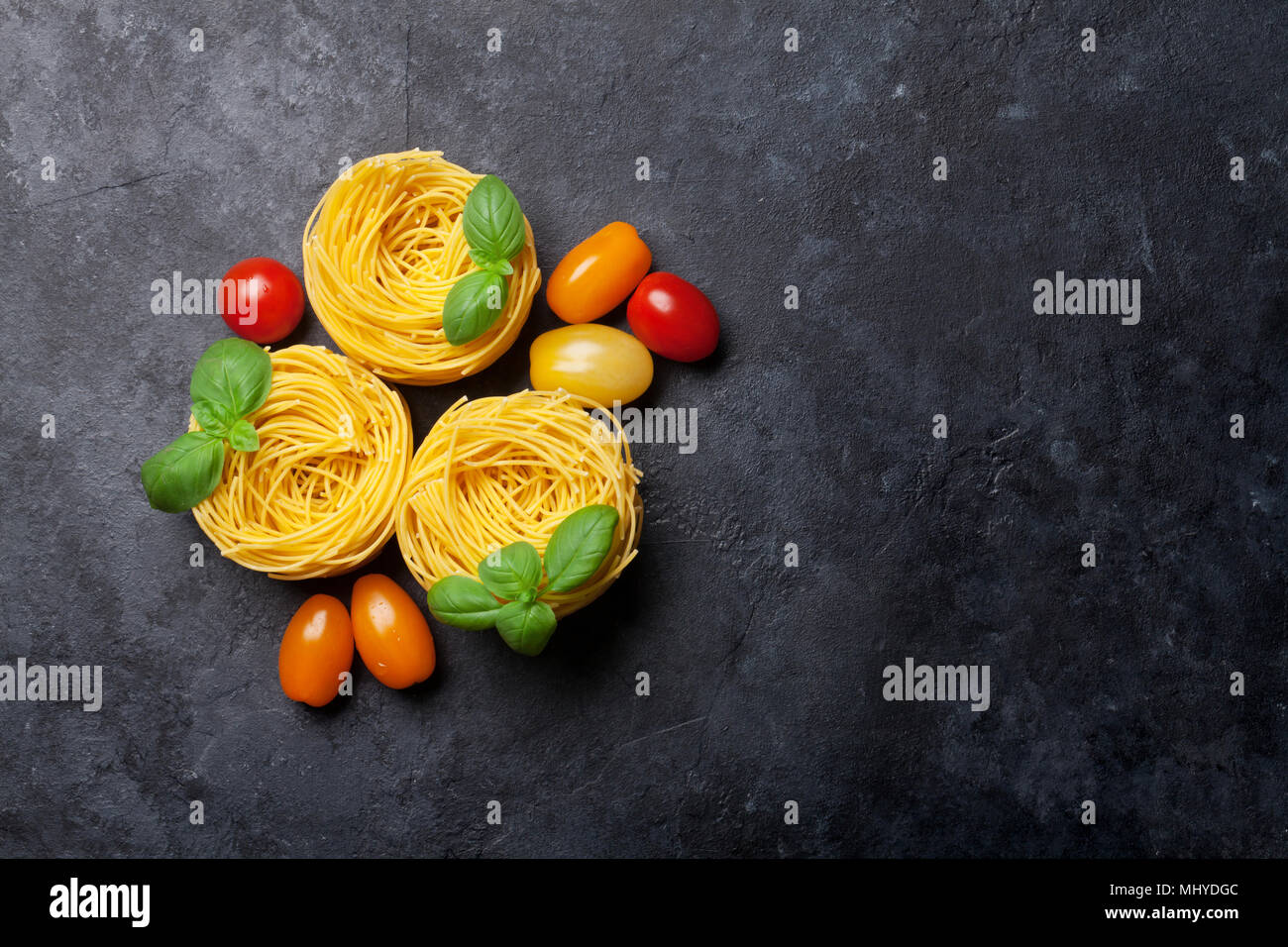 Nest pasta on stone cooking table. Top view with space for your recipe ...