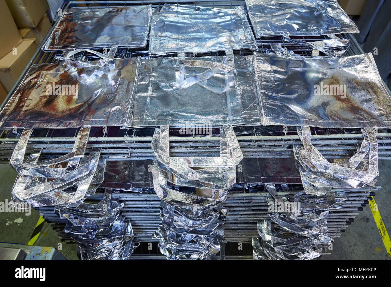 bags factory in silver fabric stacked in a row Stock Photo - Alamy