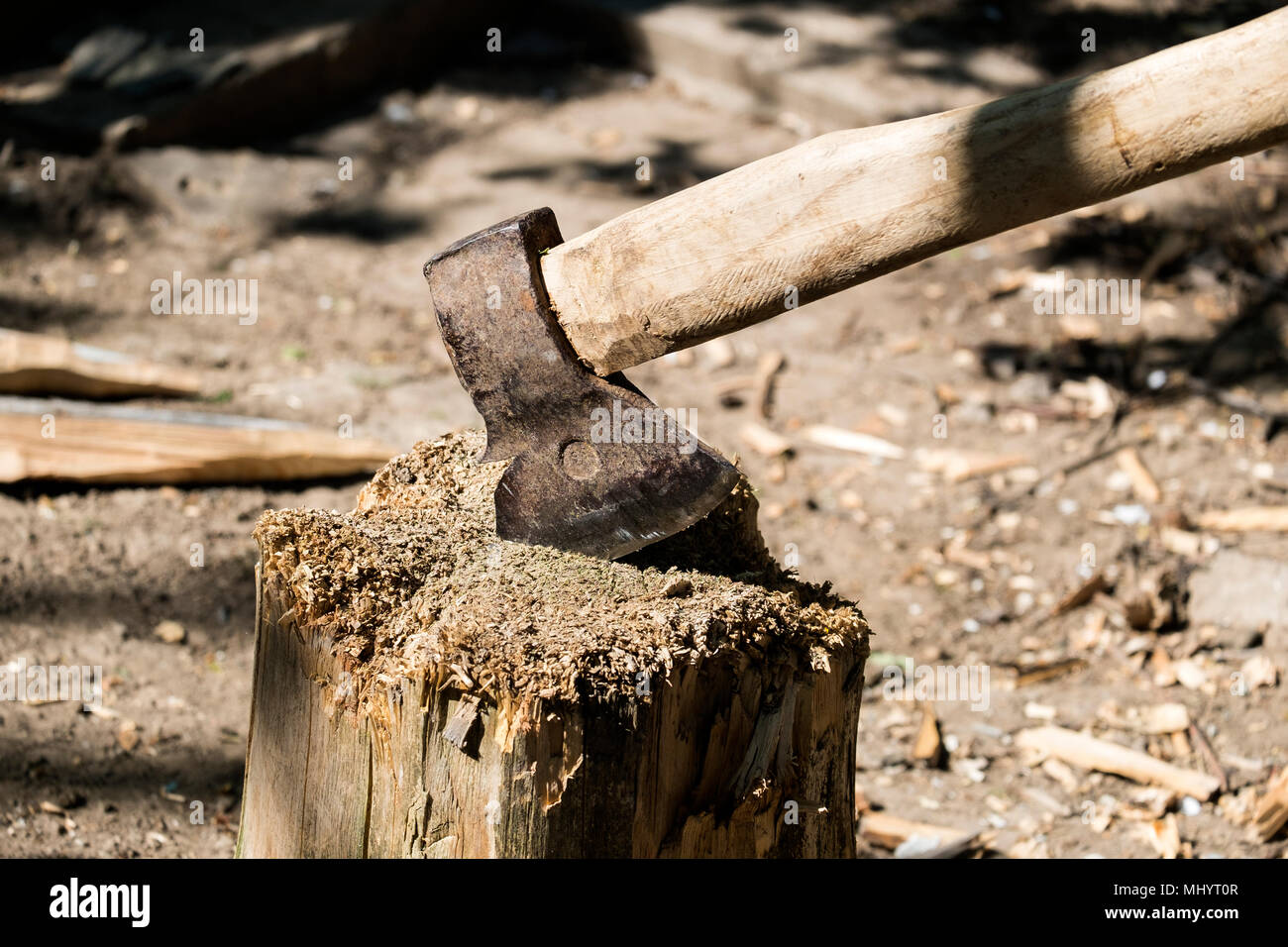 Old rusty ax stuck in a dry wooden log Stock Photo - Alamy