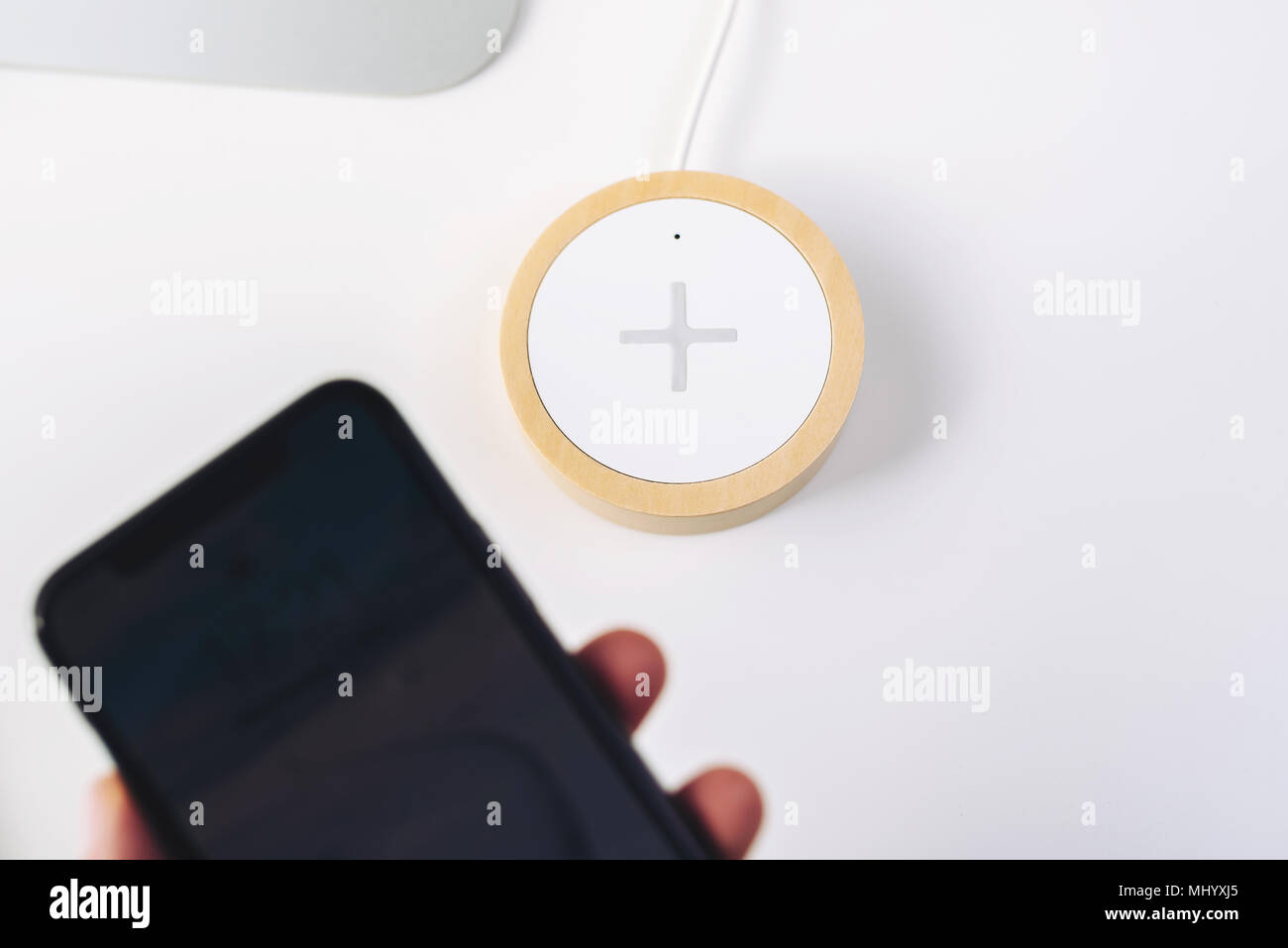 Mobile phone and wireless charger on office table. Future technology ...