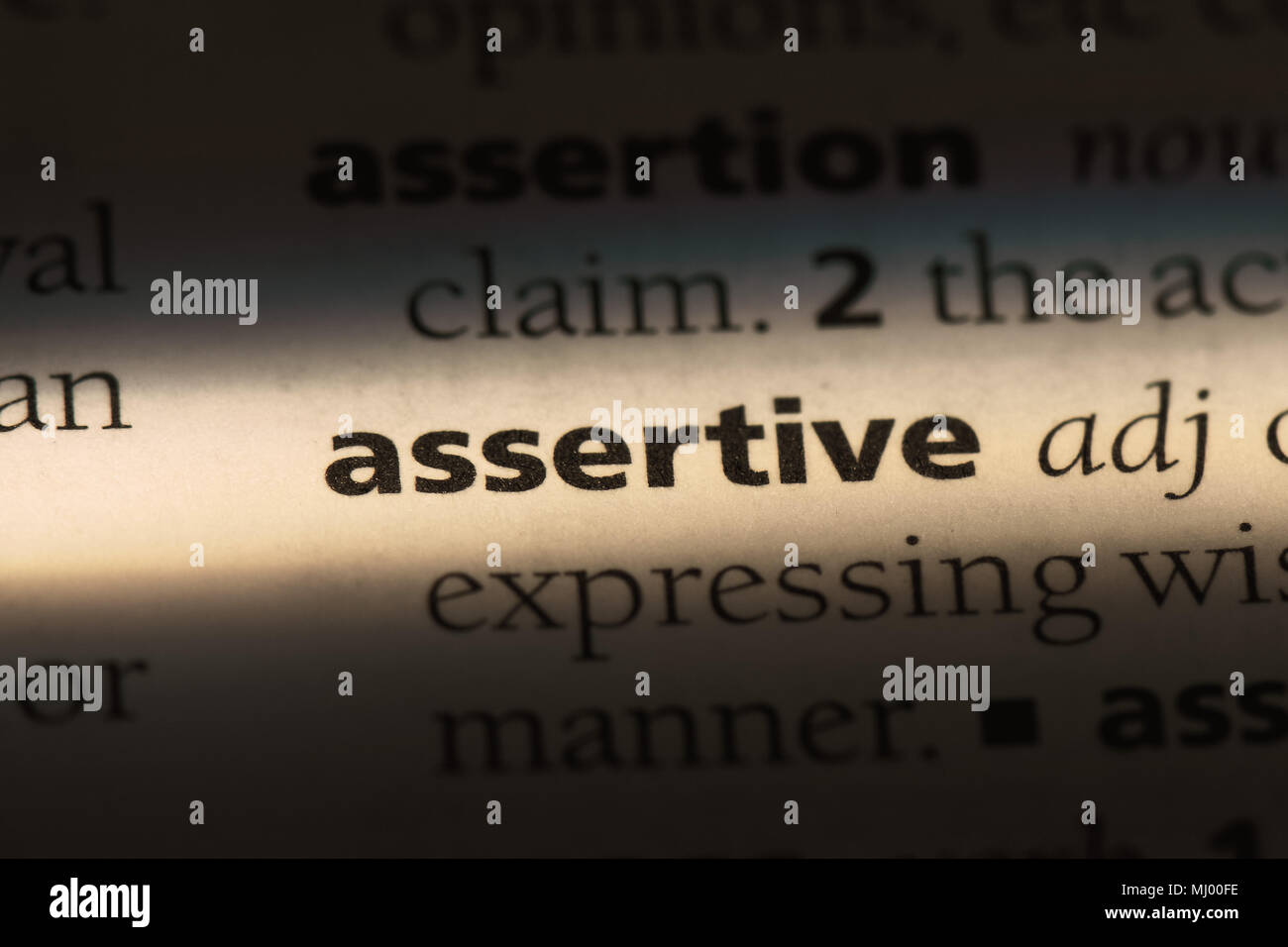 assertive word in a dictionary. assertive concept Stock Photo - Alamy
