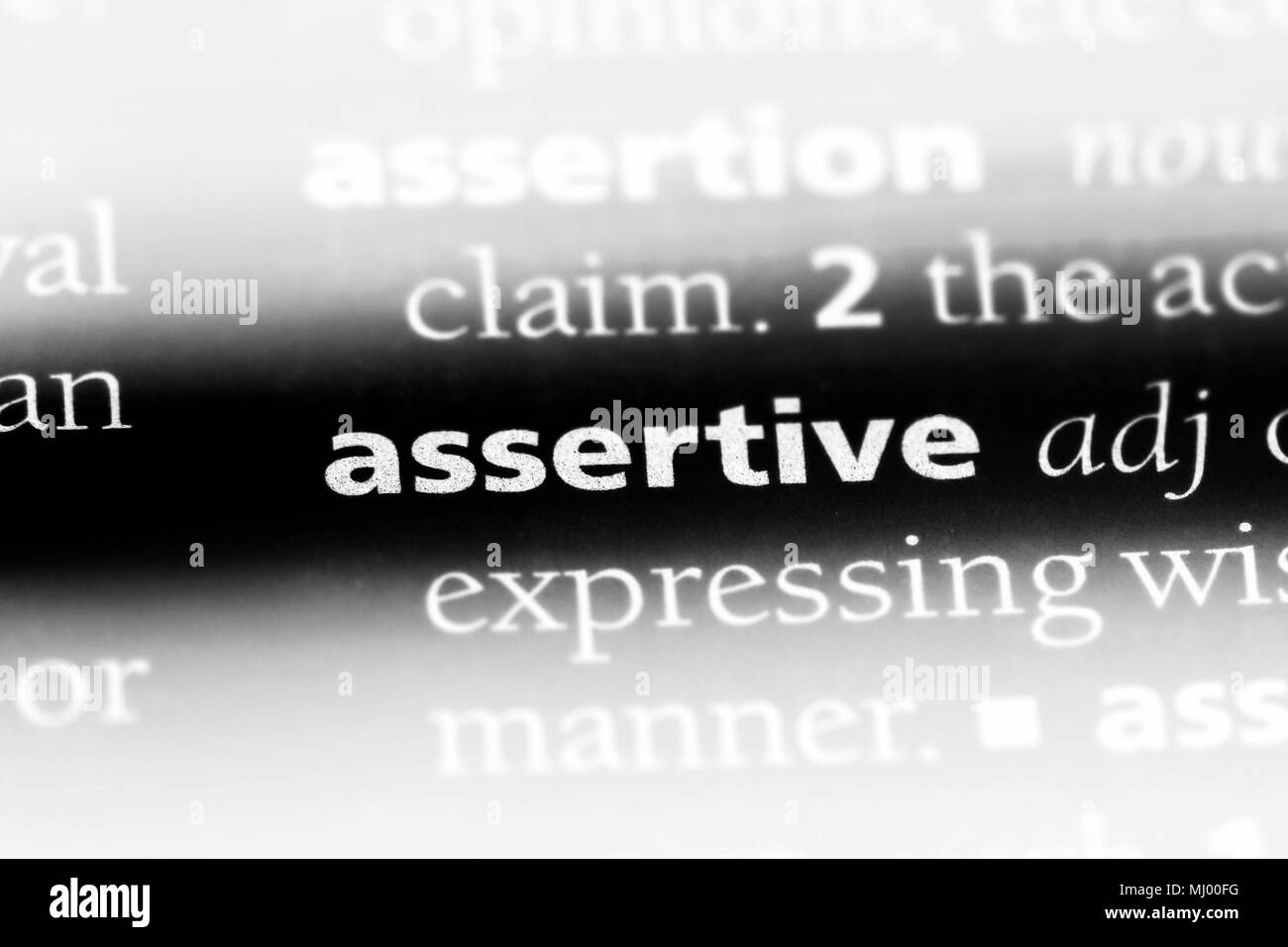 assertive word in a dictionary. assertive concept Stock Photo - Alamy