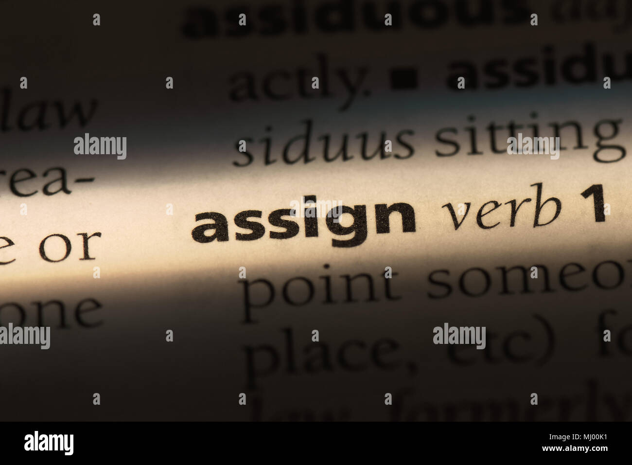 assign word in a dictionary. assign concept Stock Photo - Alamy