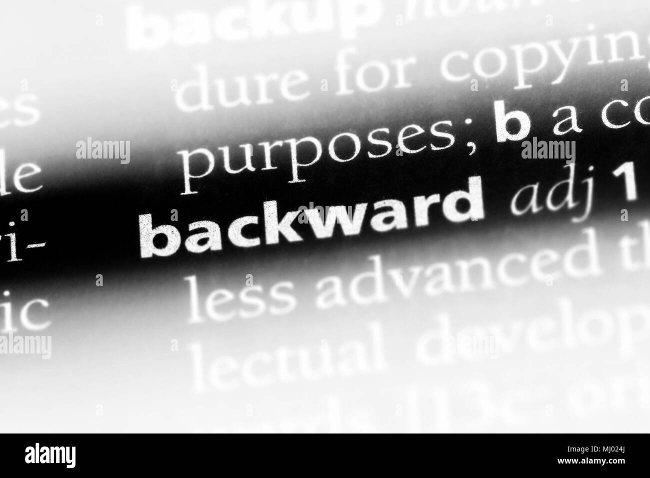 backward word in a dictionary. backward concept Stock Photo - Alamy