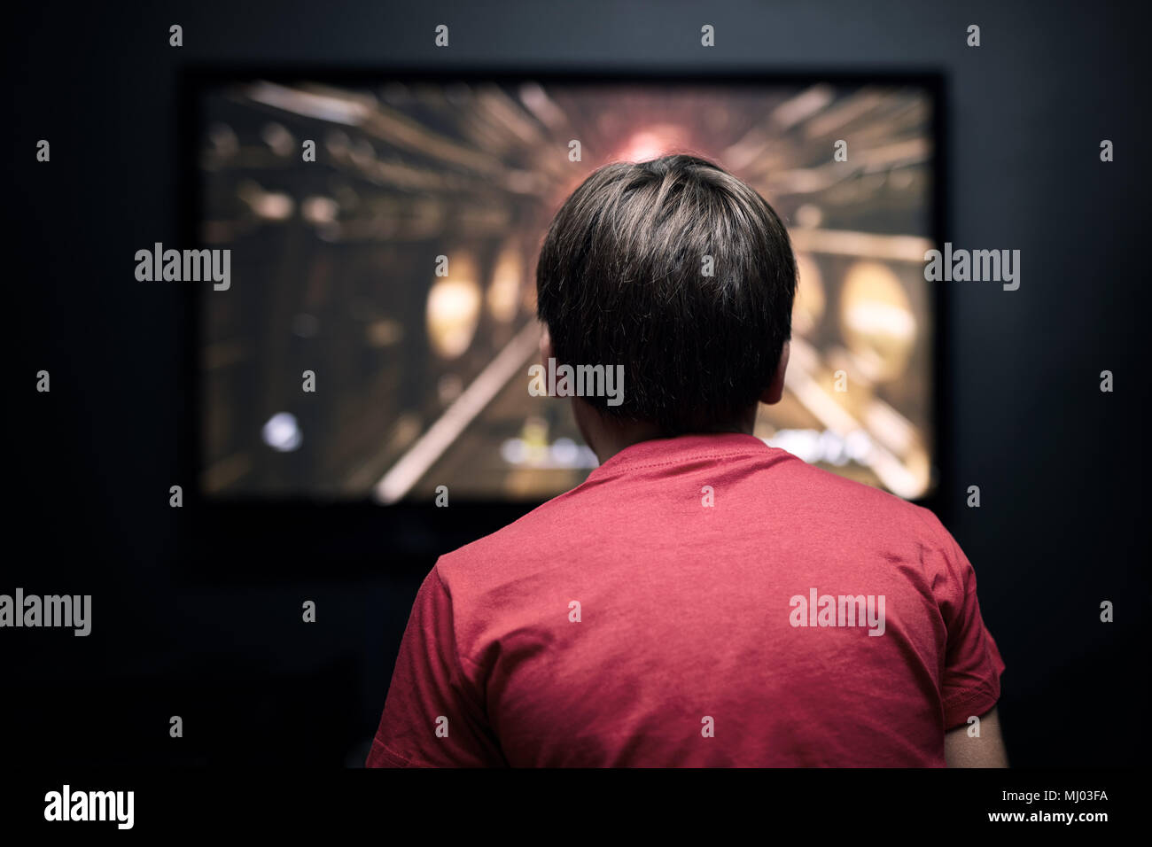 Child facing back watching tv hi-res stock photography and images - Alamy