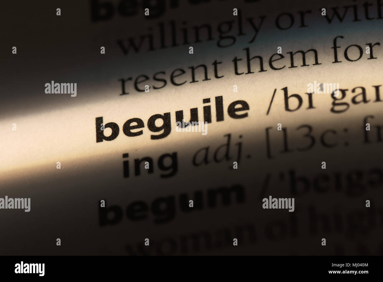 beguile word in a dictionary. beguile concept Stock Photo - Alamy