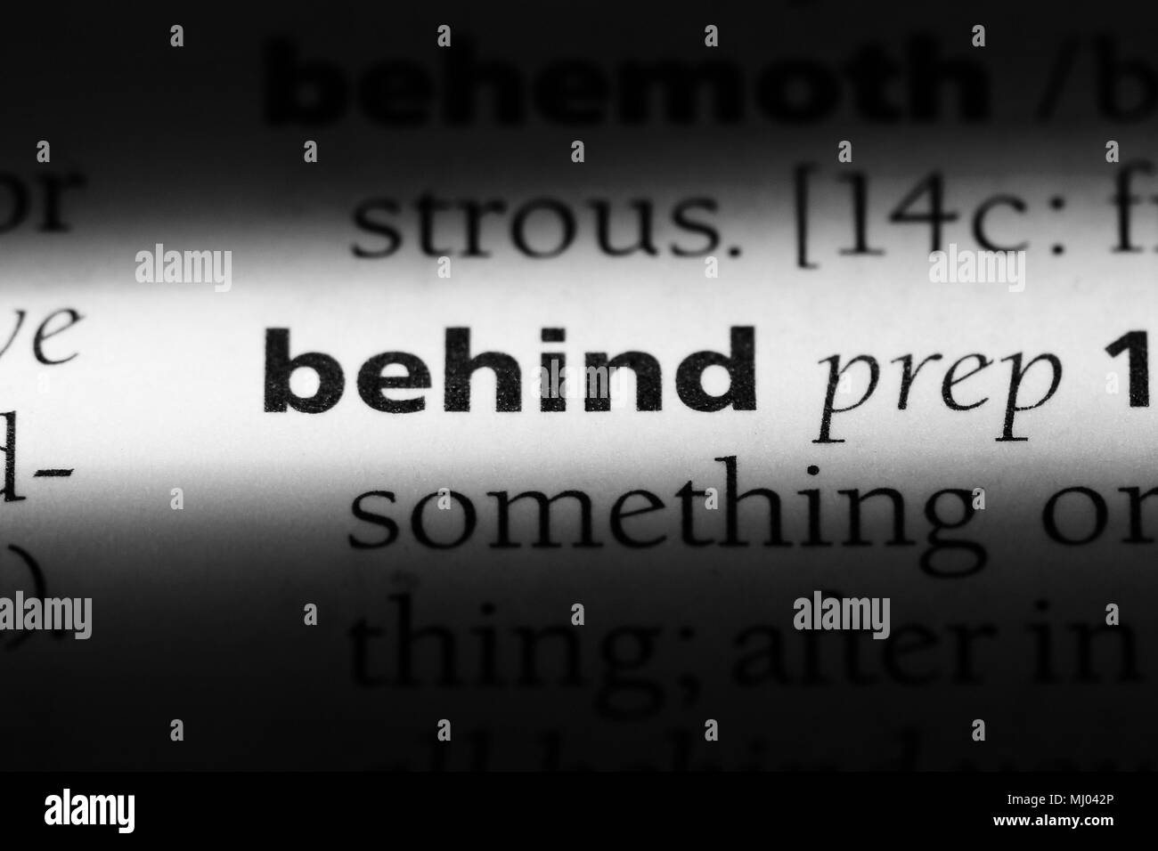 behind word in a dictionary. behind concept Stock Photo - Alamy