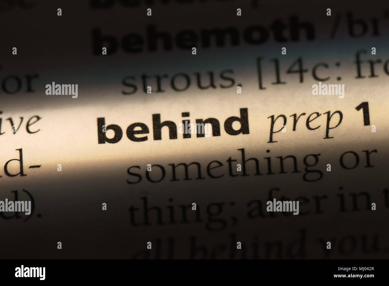 behind word in a dictionary. behind concept Stock Photo - Alamy
