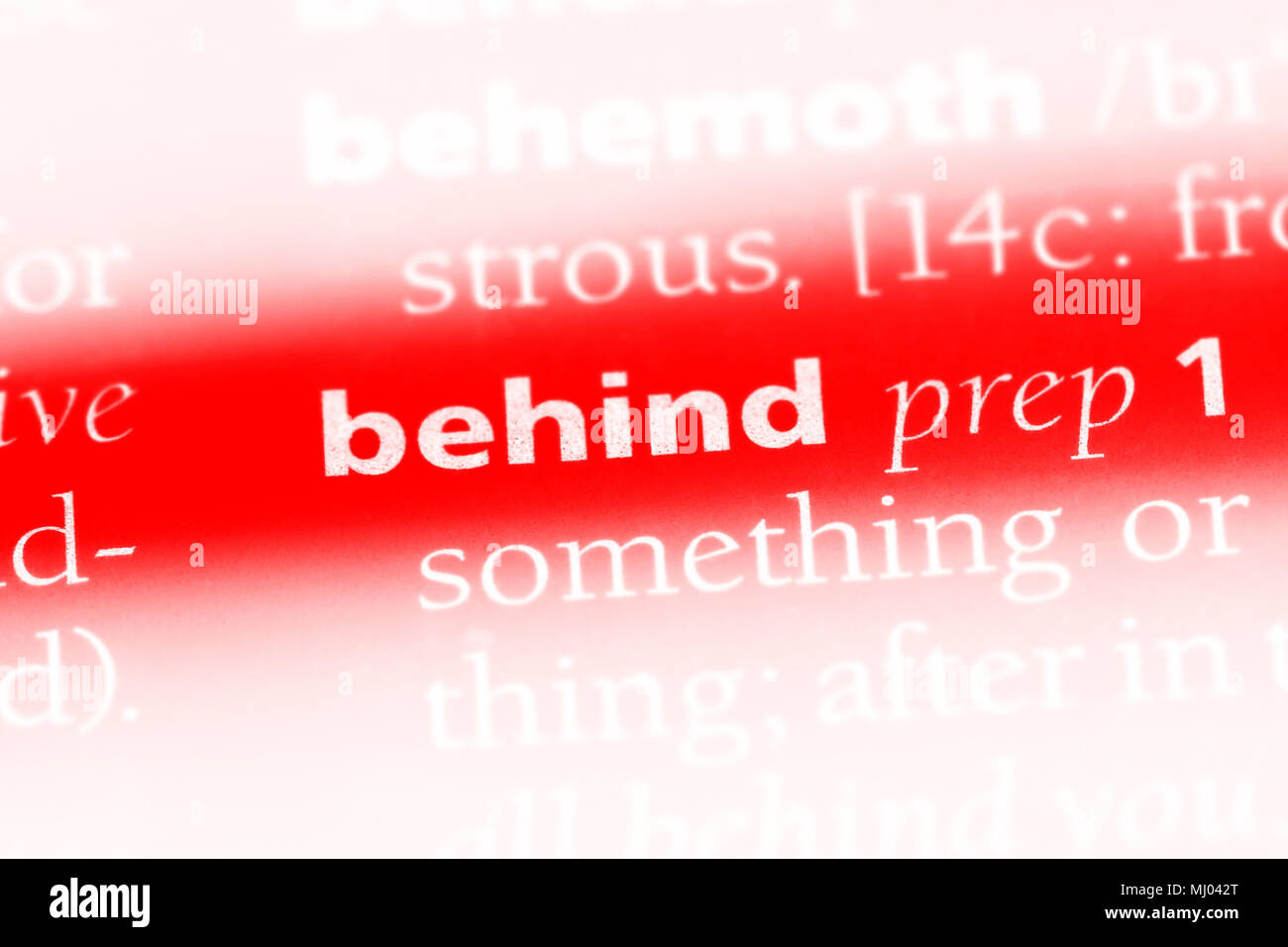 behind word in a dictionary. behind concept Stock Photo - Alamy