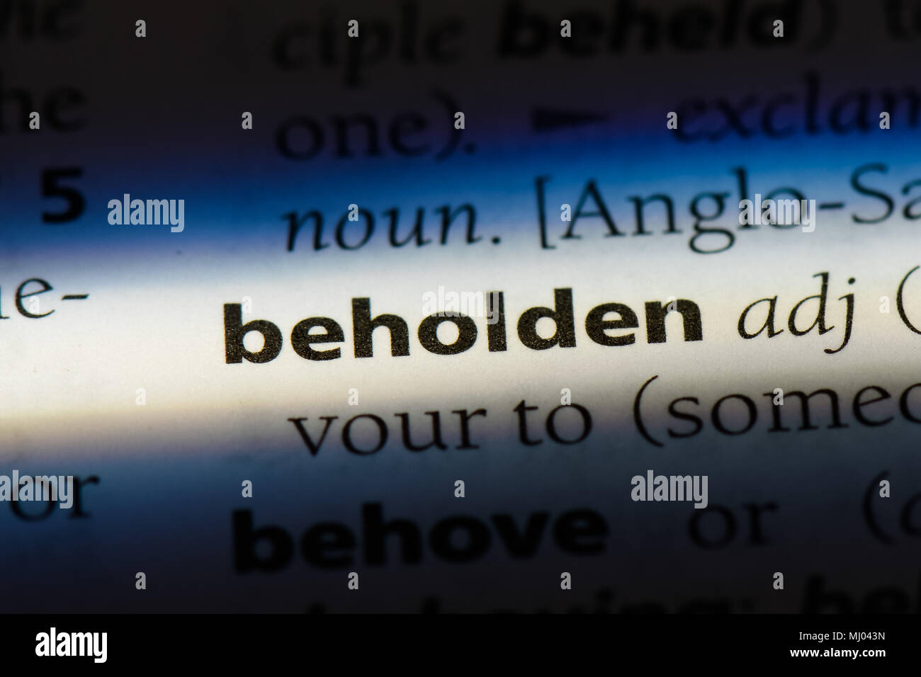beholden word in a dictionary. beholden concept Stock Photo - Alamy