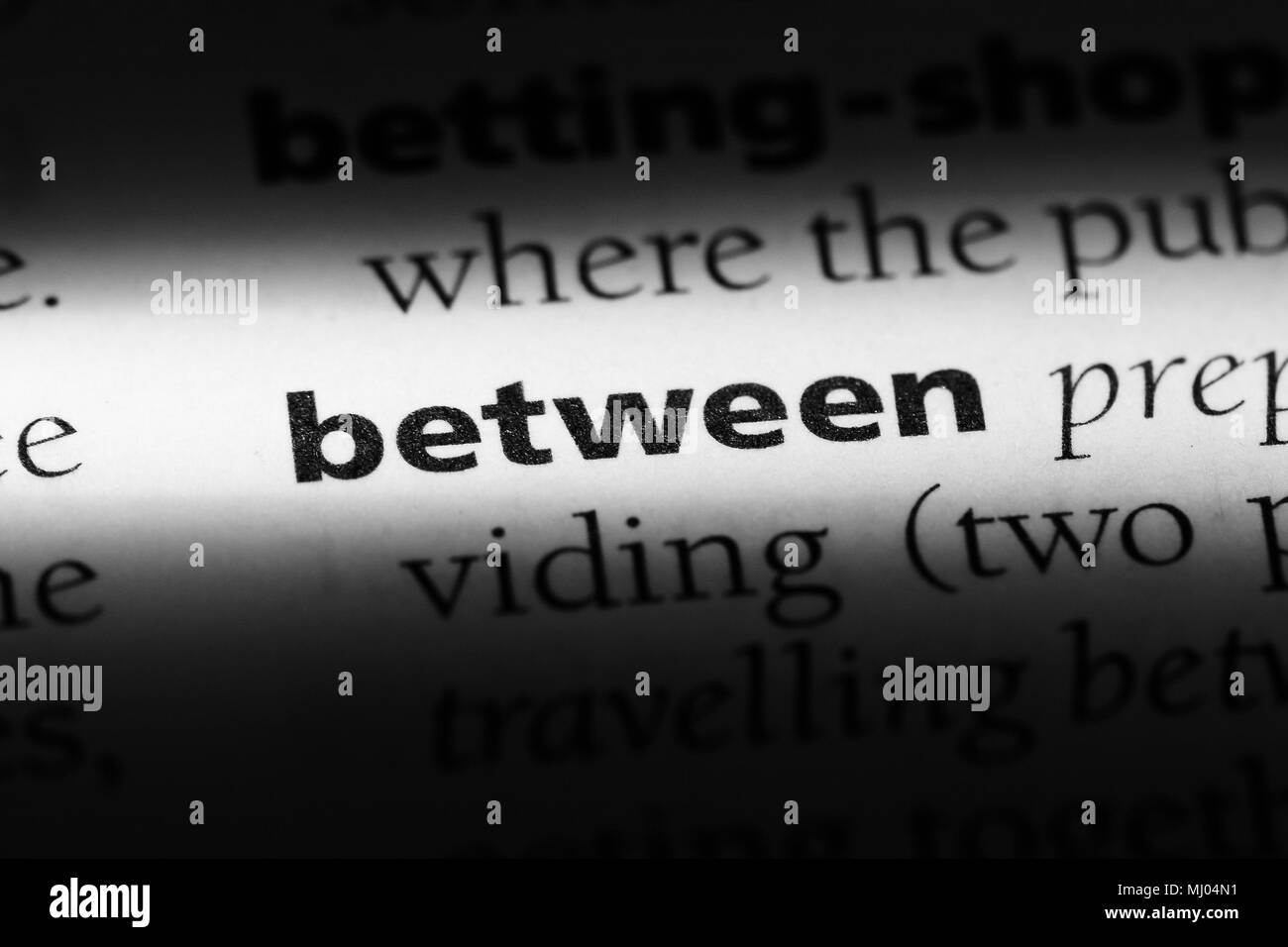 between word in a dictionary. between concept Stock Photo - Alamy