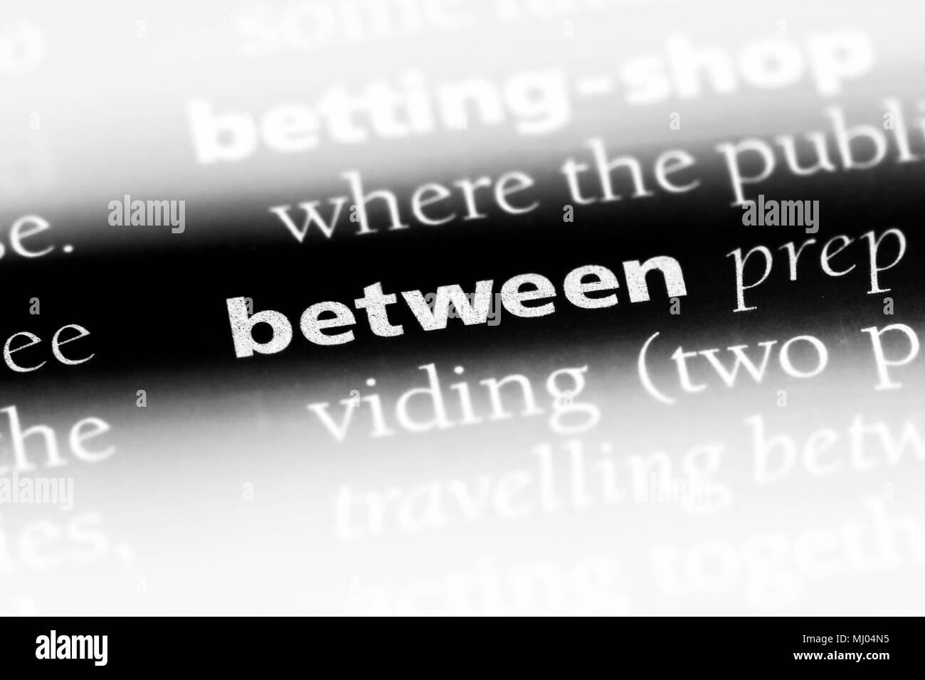 between word in a dictionary. between concept Stock Photo - Alamy