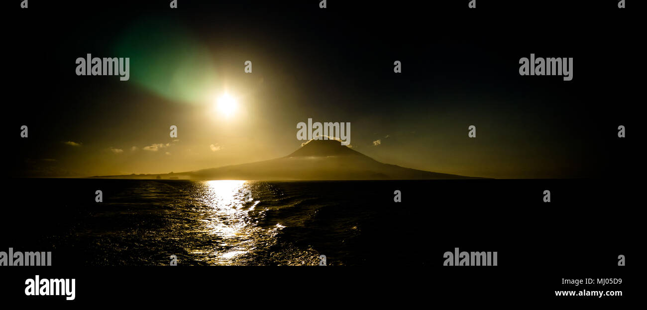 Contre jour view to Sunrise over Pico volcano and island at Azores ...