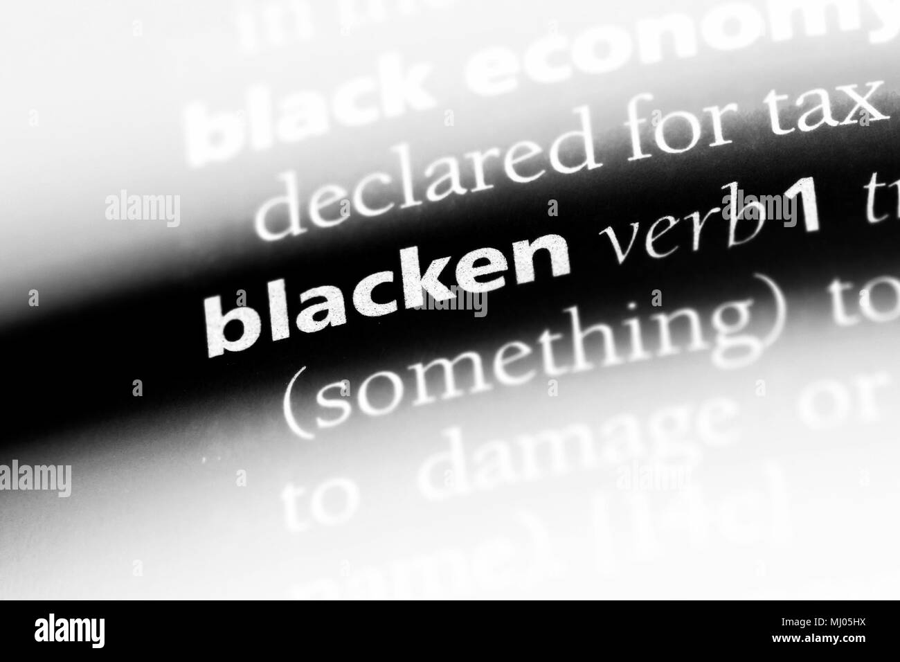 blacken word in a dictionary. blacken concept Stock Photo - Alamy