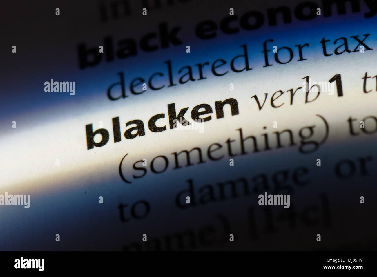 blacken word in a dictionary. blacken concept Stock Photo - Alamy