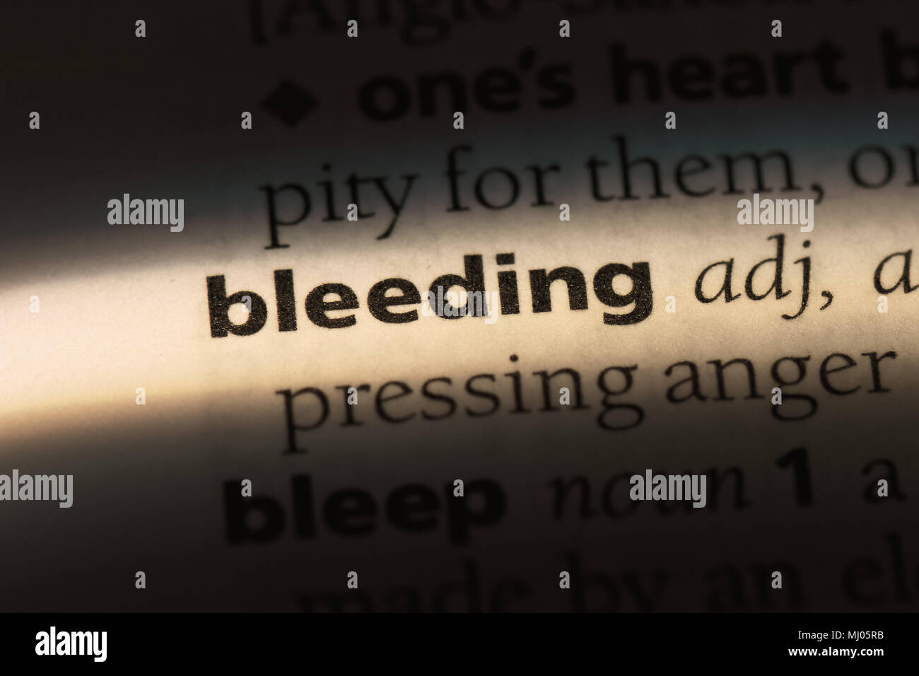bleeding word in a dictionary. bleeding concept Stock Photo - Alamy