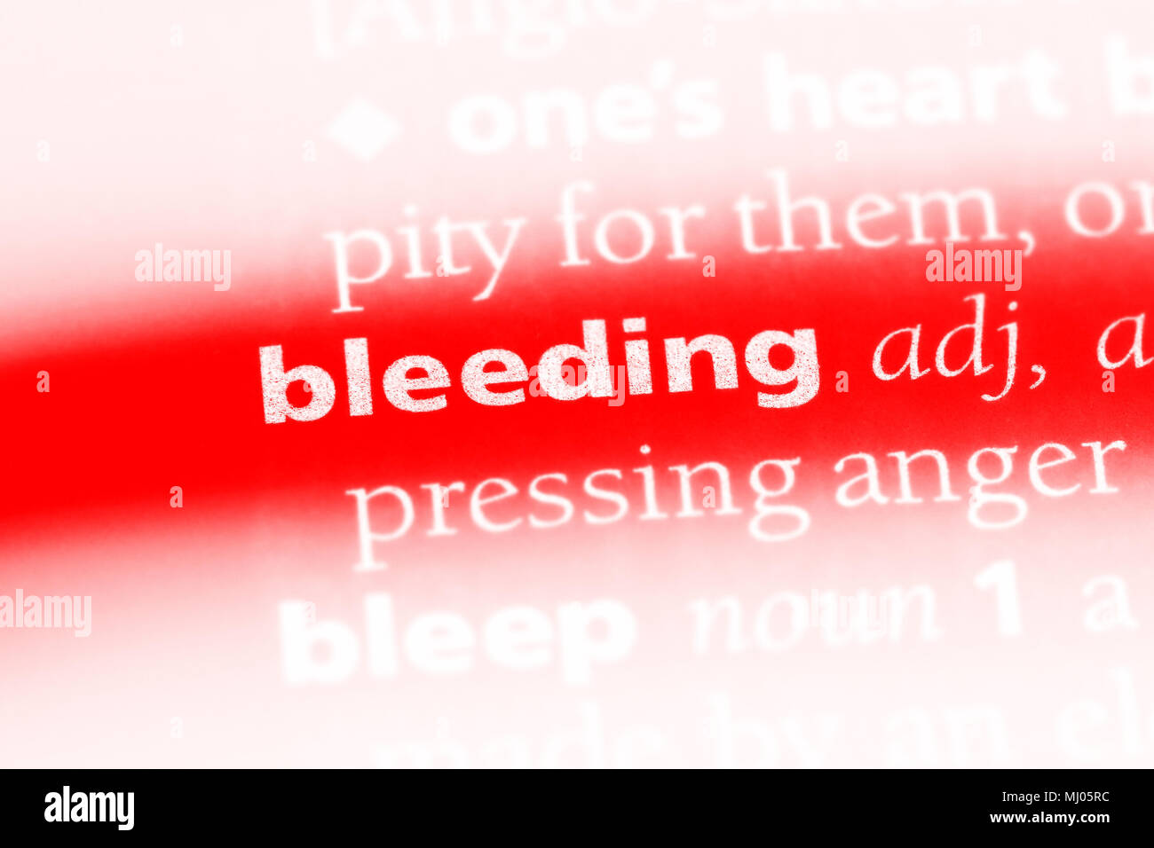 bleeding word in a dictionary. bleeding concept Stock Photo - Alamy