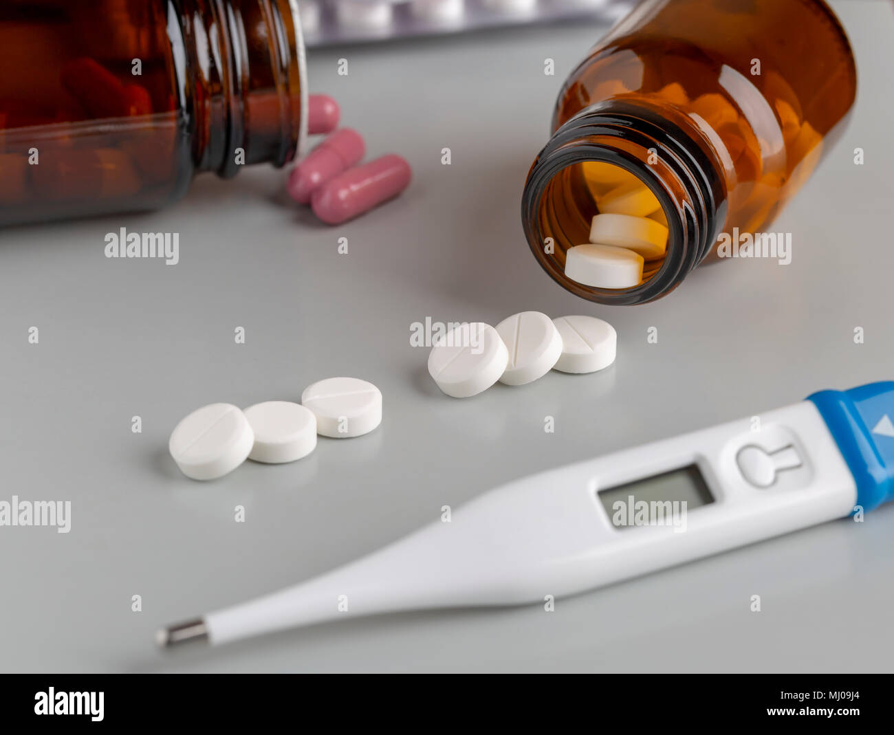 electronic thermometer and pills bottles Stock Photo - Alamy