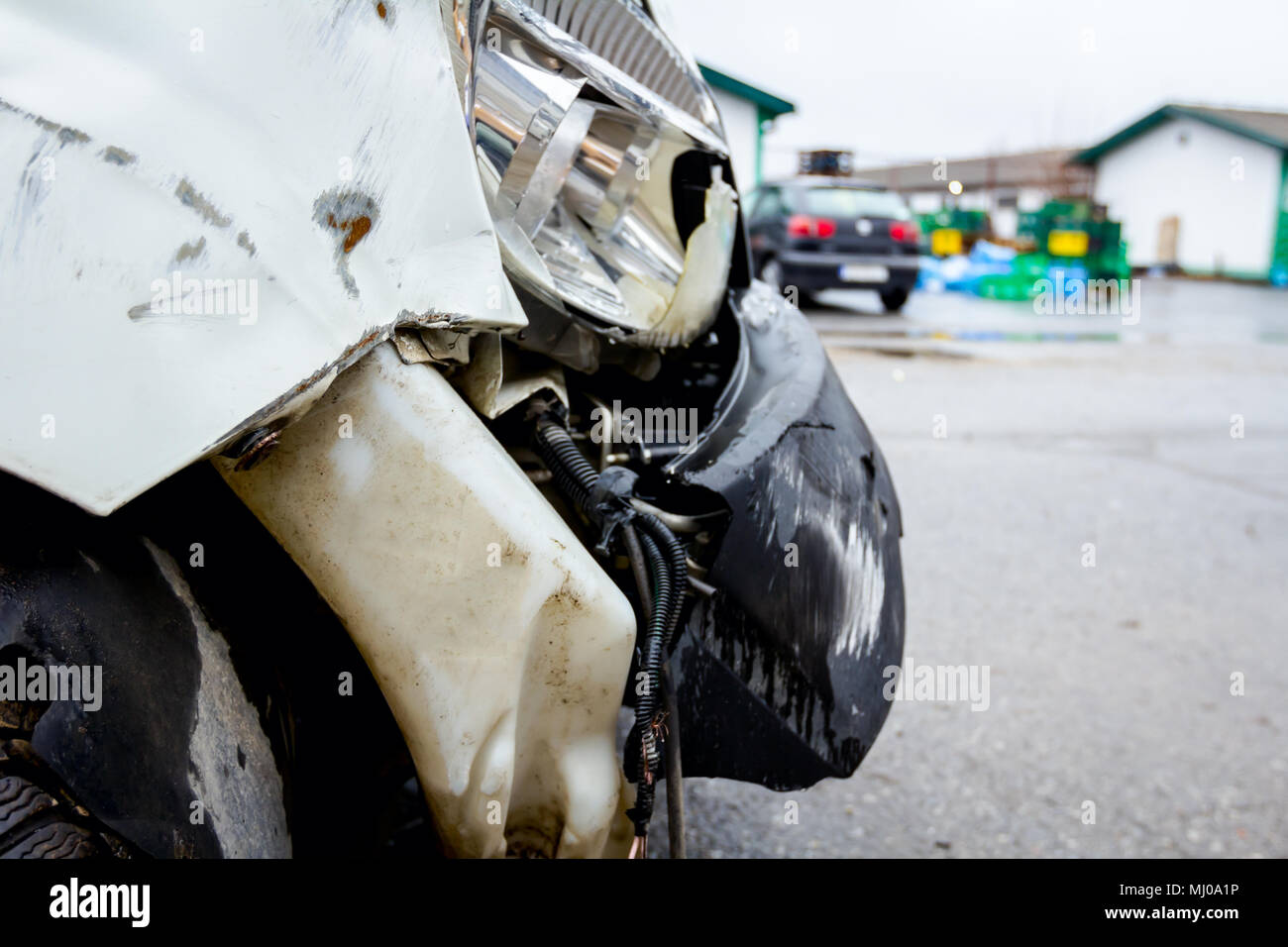 Detail after a front car crash accident, wrecked and crashed headlamp ...
