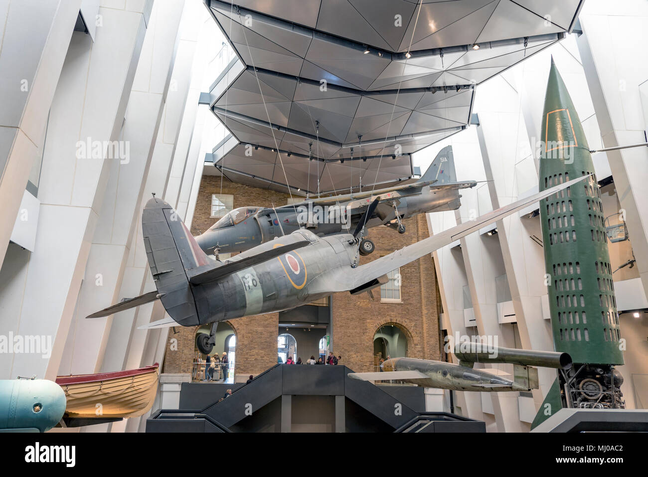 Modern jet fighter and Spitfire on display at the Imperial War Museum ...
