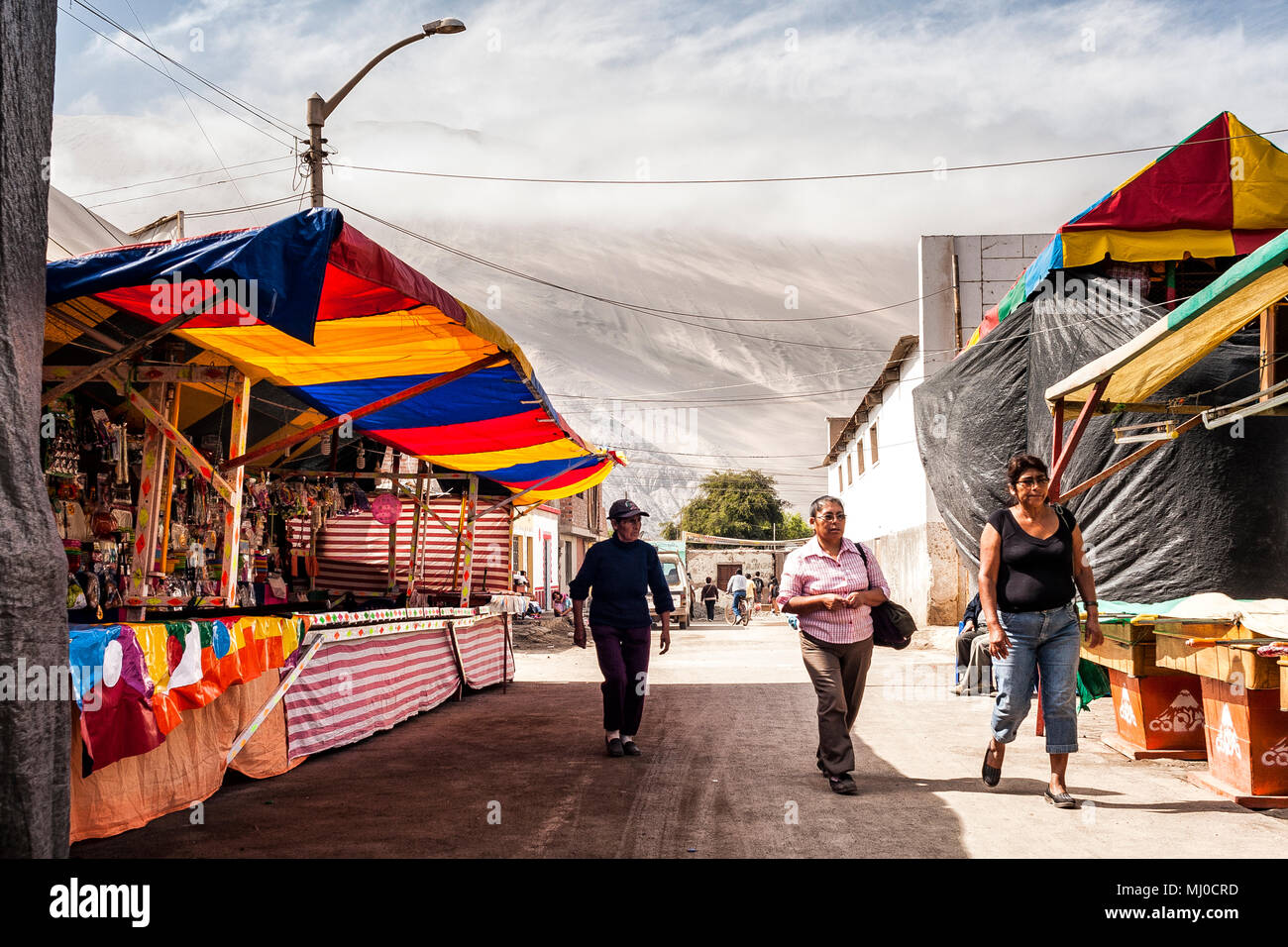 View of a dirt street and Cerro Toro Mata in the background. Acari ...