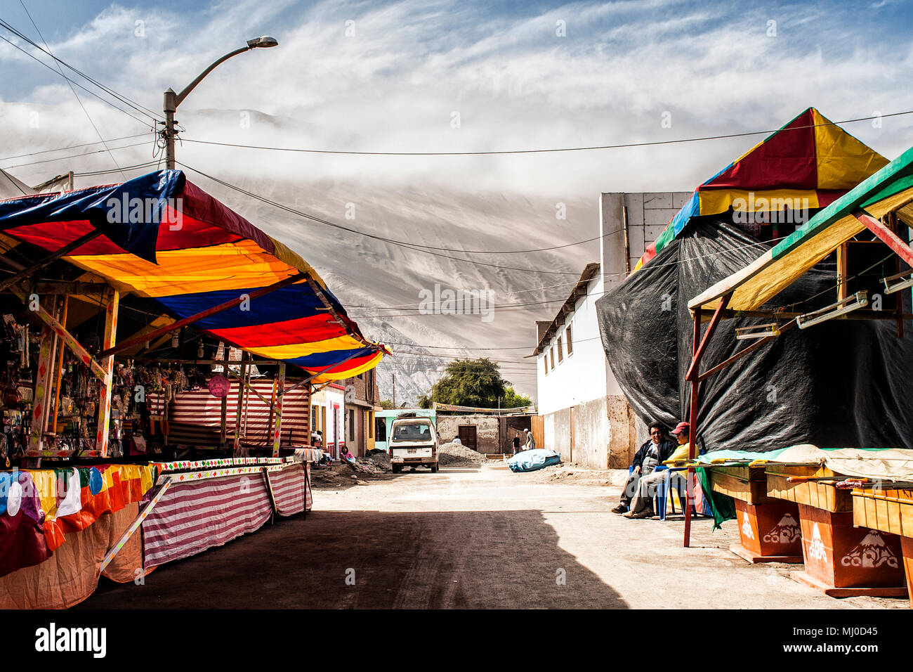 View of a dirt street and Cerro Toro Mata in the background. Acari ...