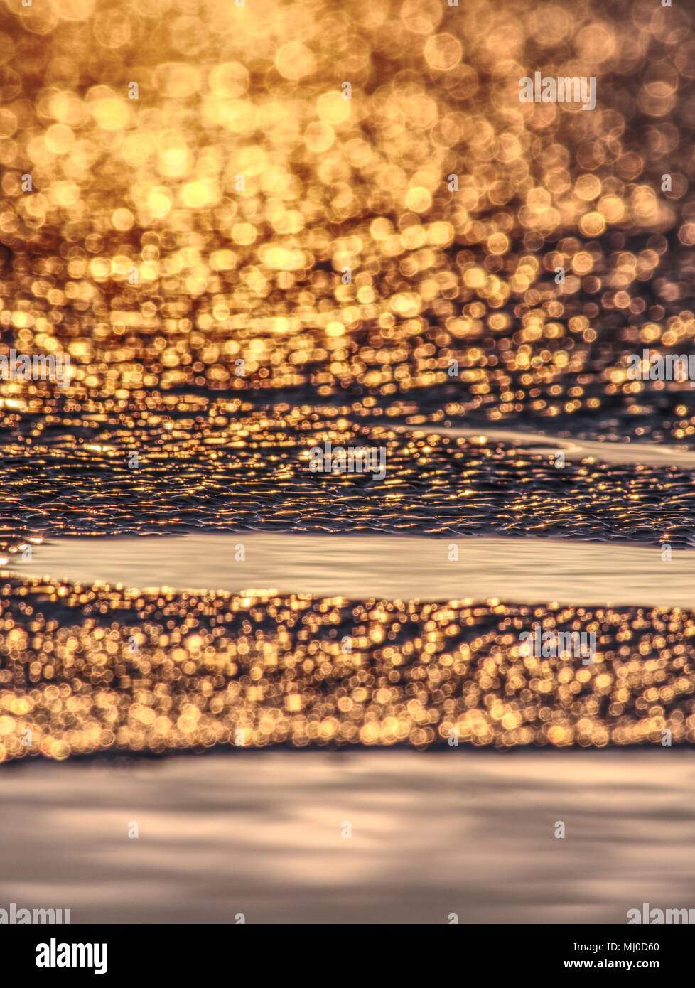 Water and ice edge. Ice with purple brilliant color covered the dark ...