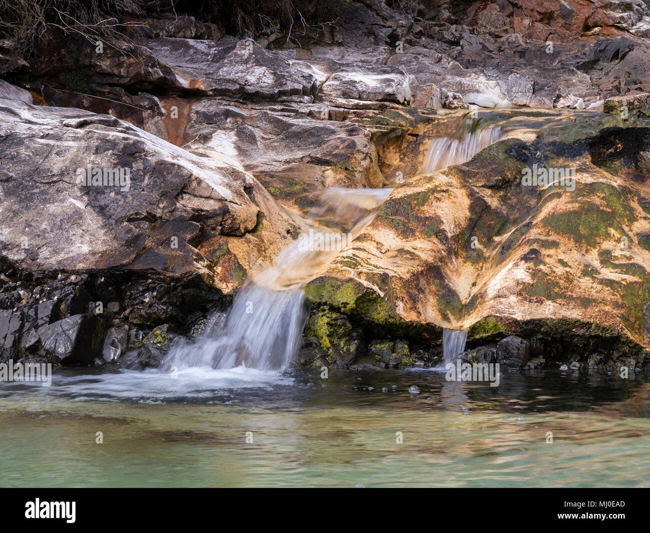 Small waterfall over rocky white marble stream bed, Allt Aigeinn ...