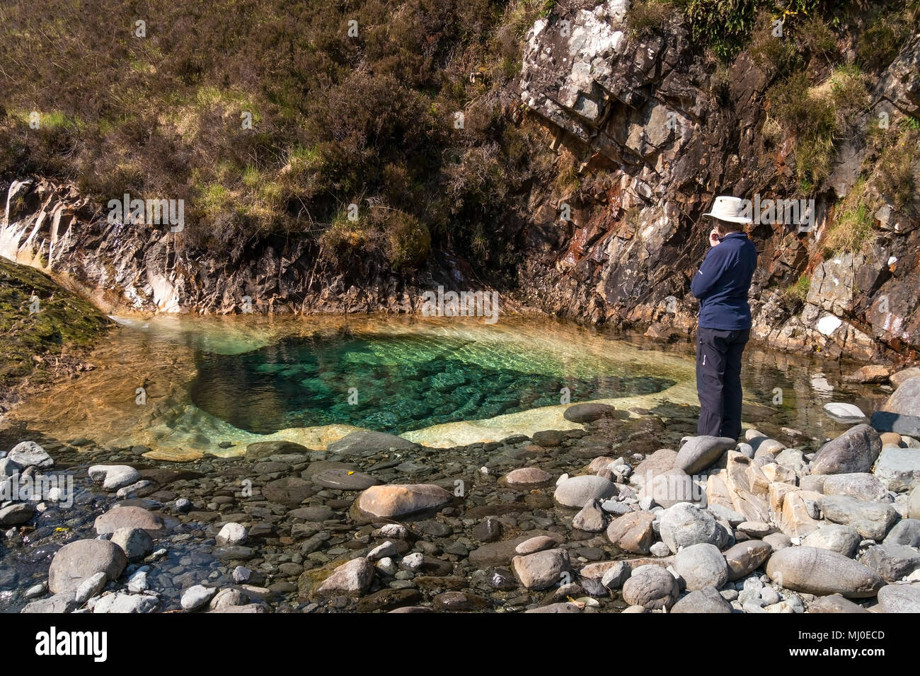 Rock pool eroded into Skye white marble slab in mountain stream bed of ...