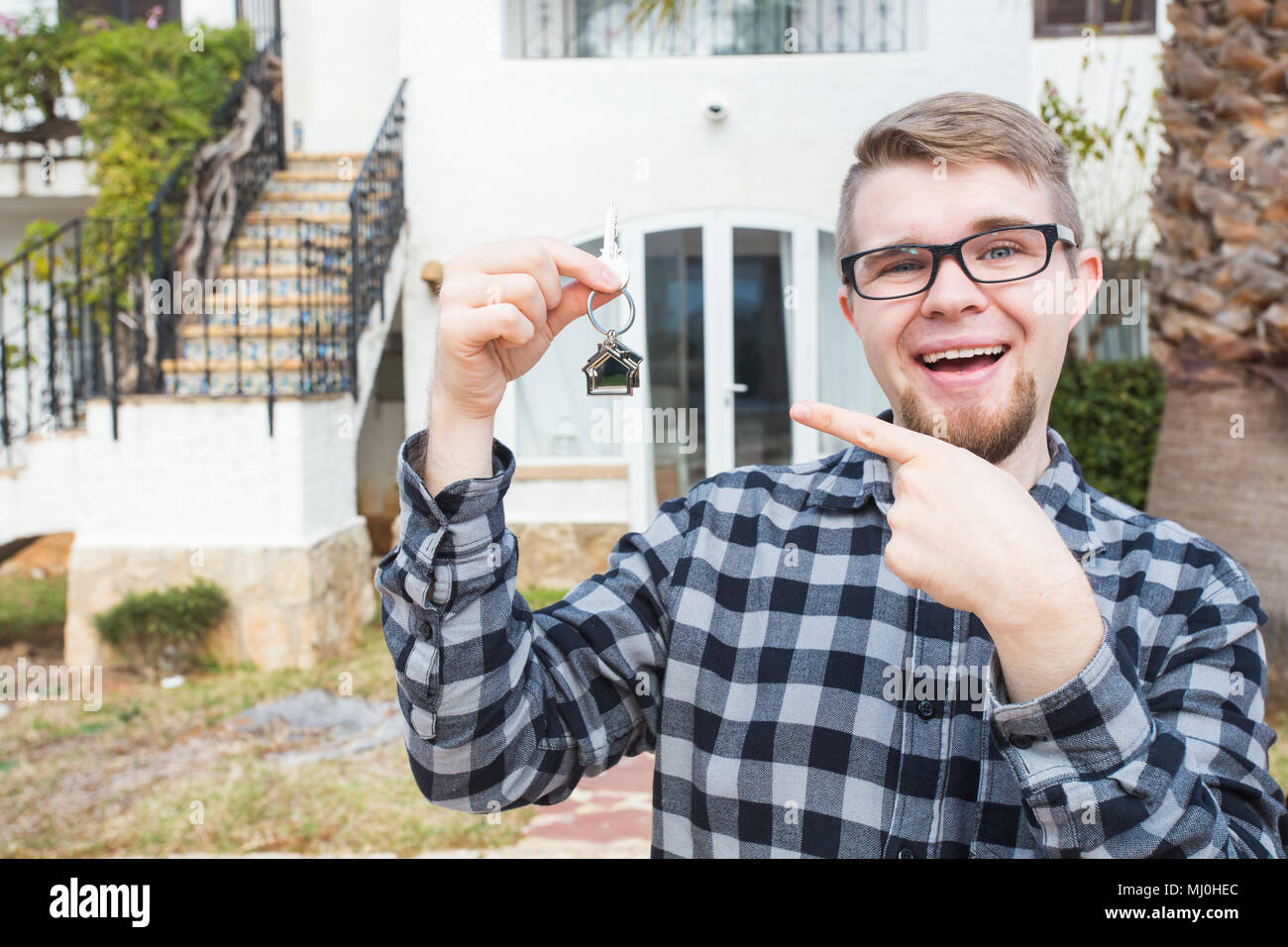 Young happy man showing a house key Stock Photo - Alamy