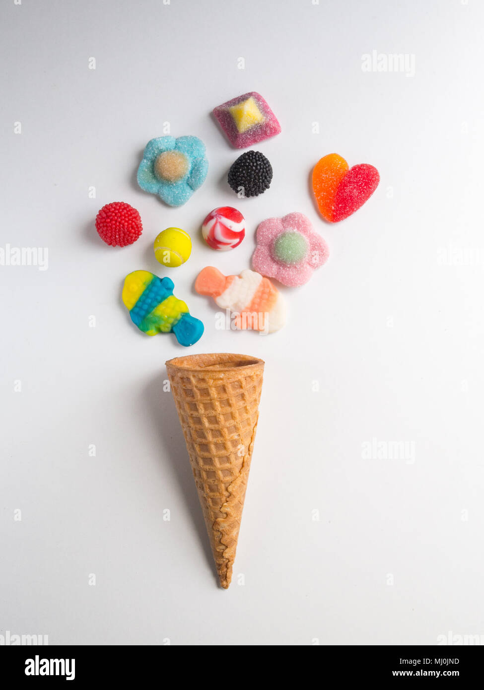 Ice cream cone with jelly candies on white background Stock Photo - Alamy