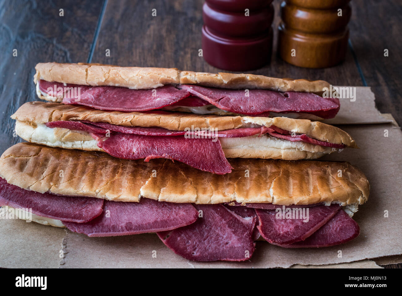 Dilli Kasarli / Beef Tongue Sandwich on a wooden surface Stock Photo ...