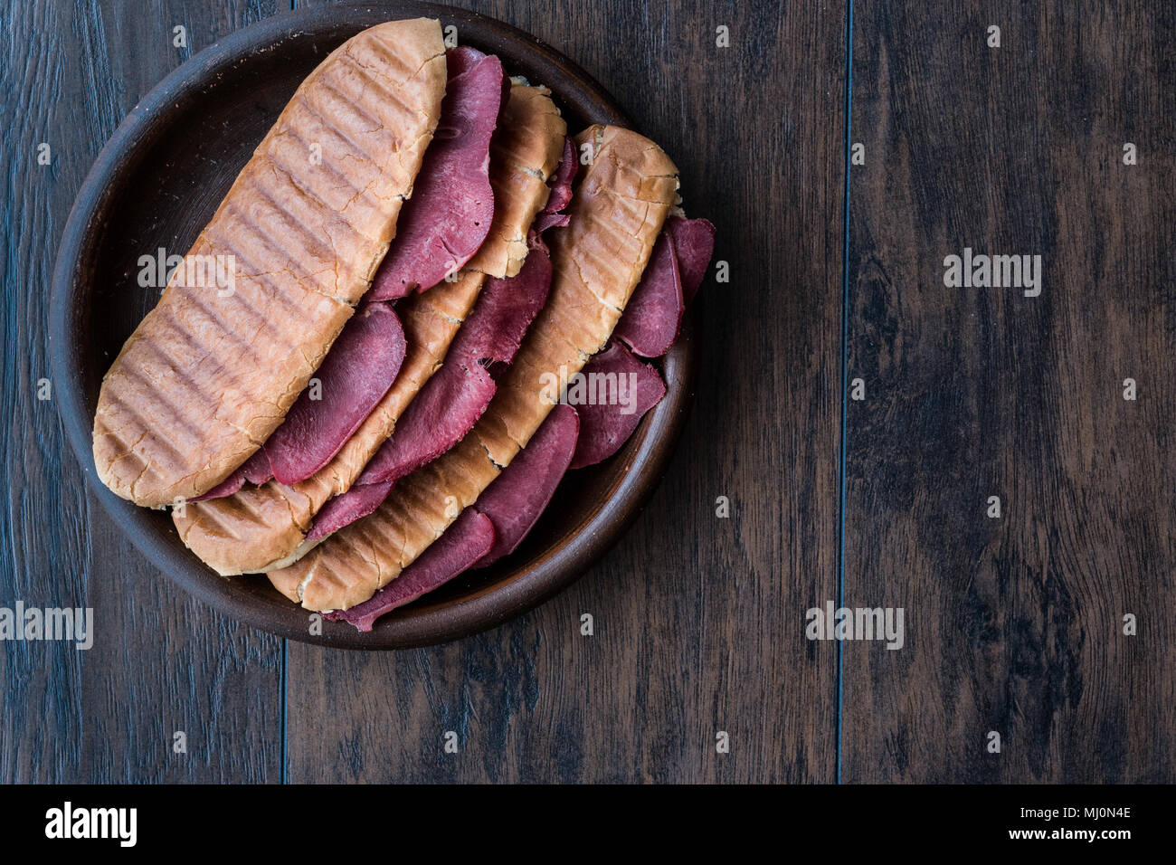 Dilli Kasarli / Beef Tongue Sandwich on a wooden surface Stock Photo ...