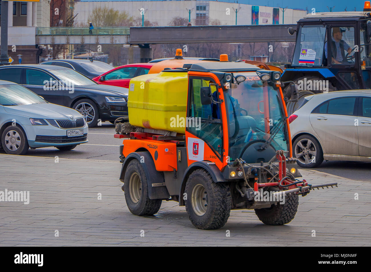 MOSCOW, RUSSIA- APRIL, 24, 2018: Outdoor view of man driving a cleaning ...